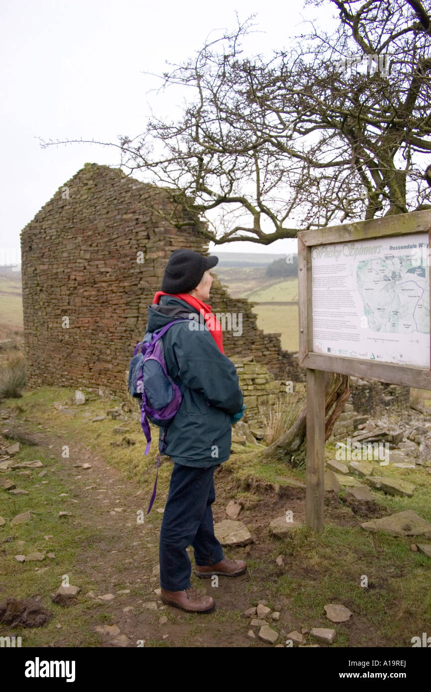 Female walker reading an information board on the Rossendale Way near ...