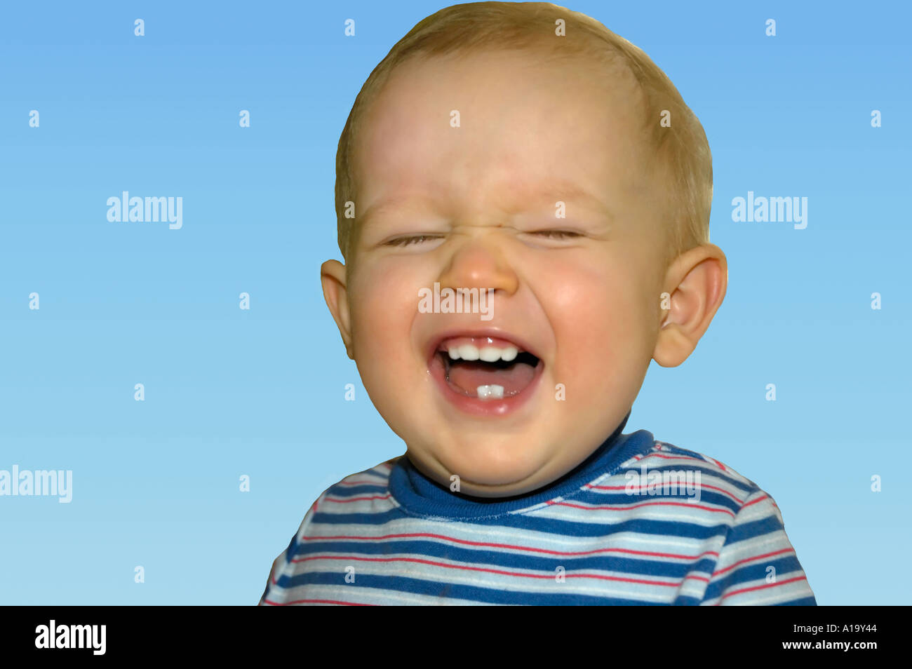 Laughing boy toddler with a toothy smile and eyes shut Stock Photo - Alamy