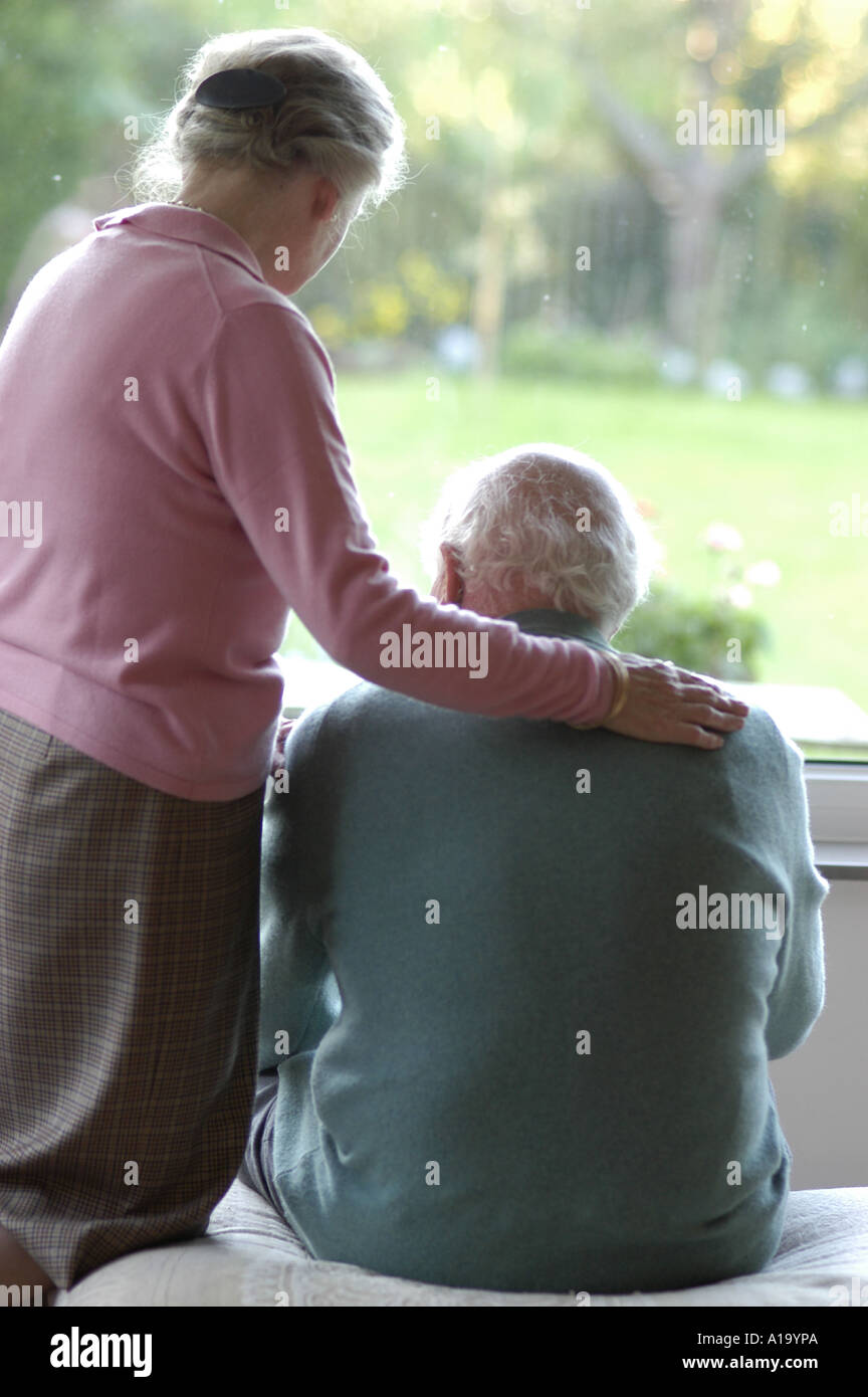 backview of elderly couple at window Stock Photo - Alamy