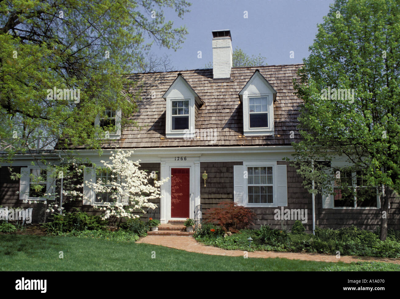 Cape Cod style house of wood shakes and path in Spring - four seasons ...