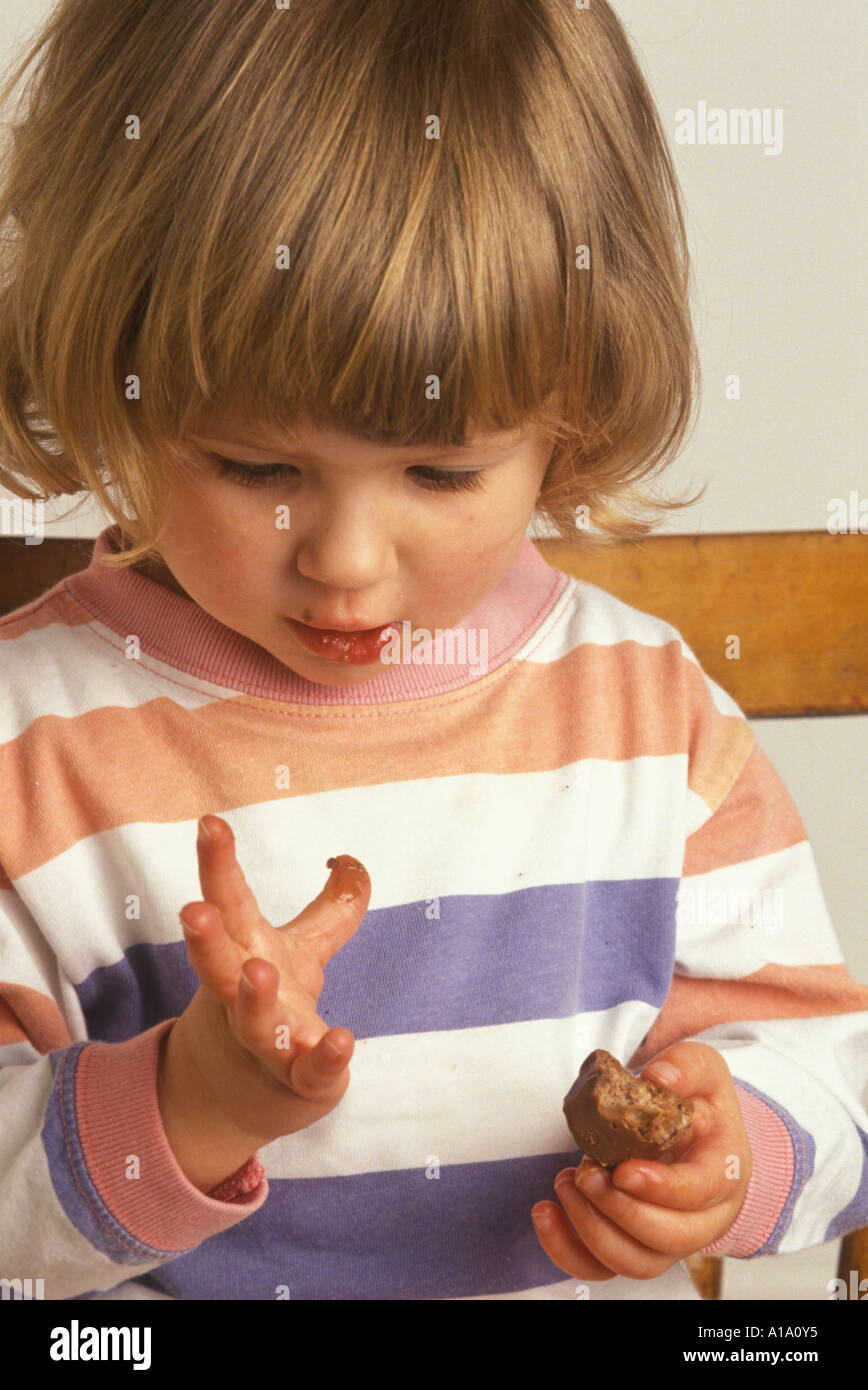 little girl eating chocolate Stock Photo - Alamy