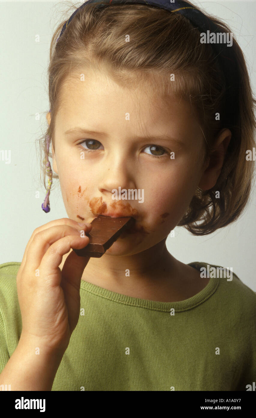 little girl eating chocolate with a smeared face Stock Photo - Alamy