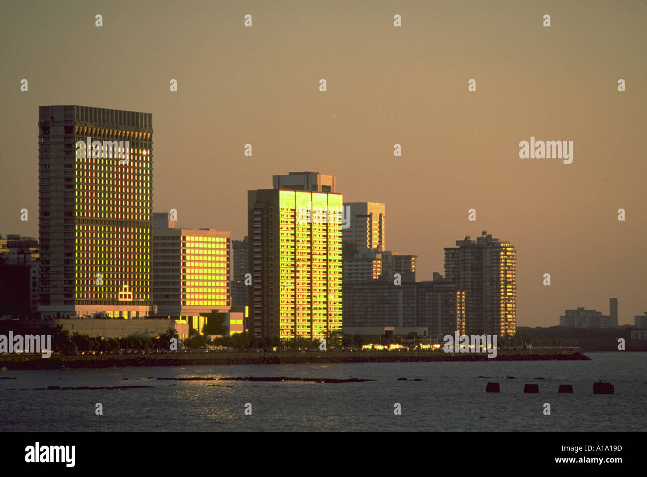 Skyscrapers on Nariman Point skyline at sunset with sun reflecting on ...