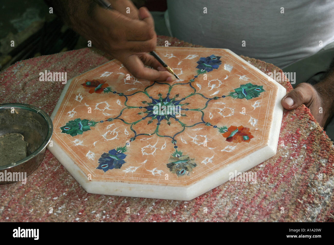 Marble plate with gemstone inlays, stonecutter engraving ornaments ...