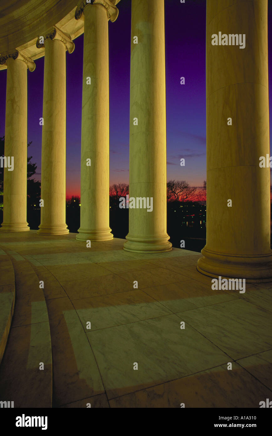 Marble columns in circular formation around building at night with ...