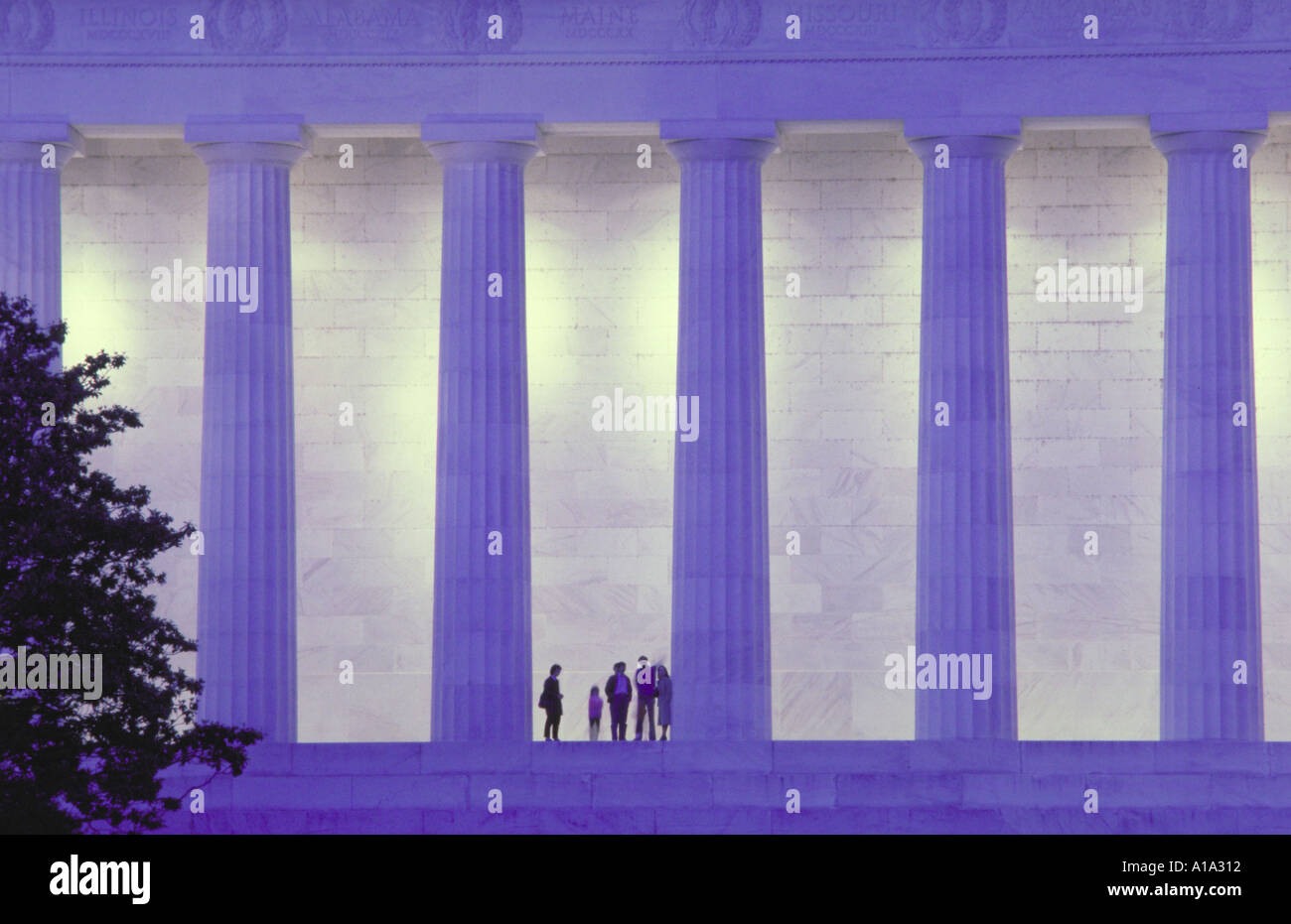 Several people stand between the columns of the Lincoln Memorial at ...