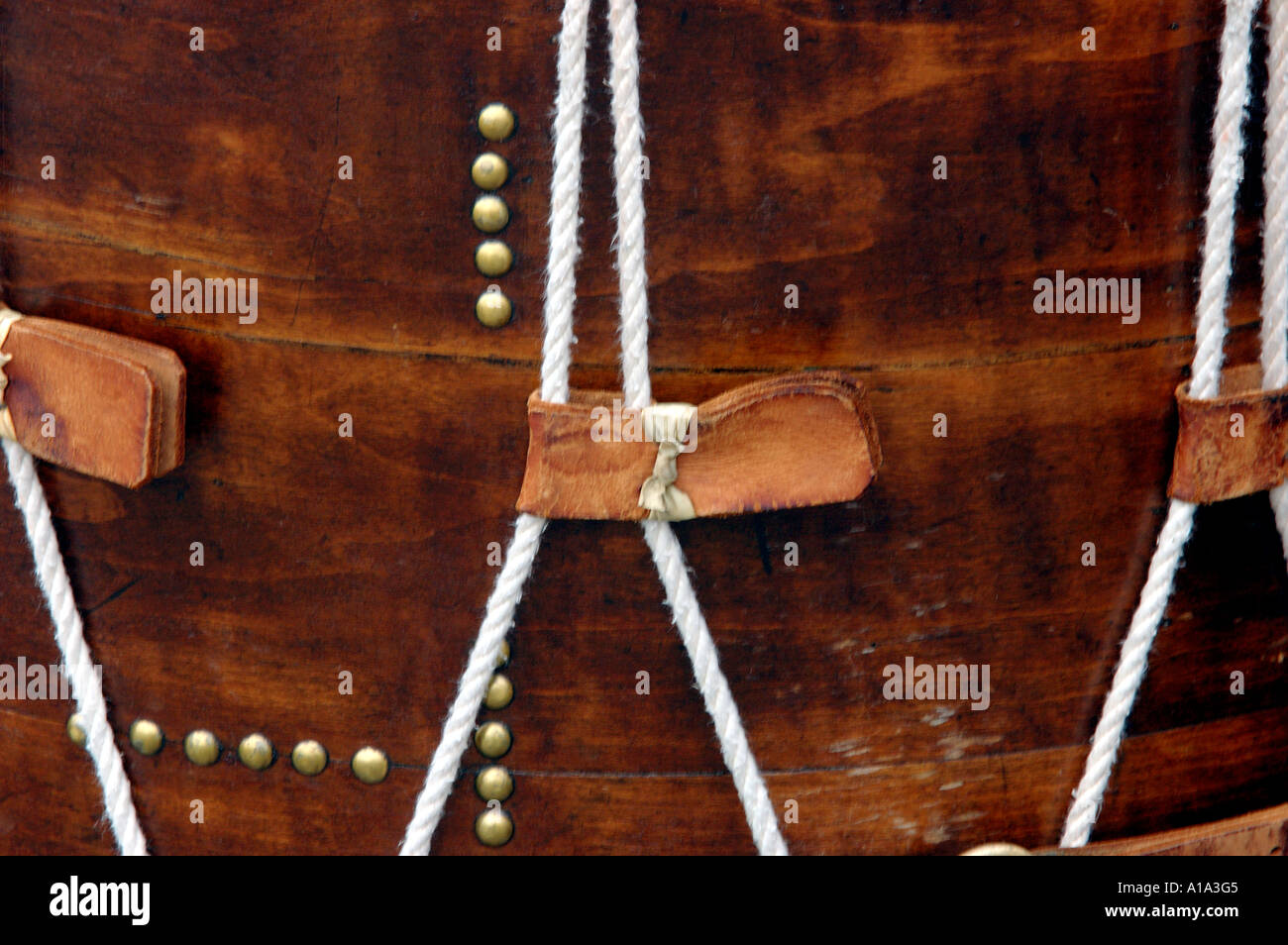 Drum brown tan strap rope white rope wood panel close up musical ...