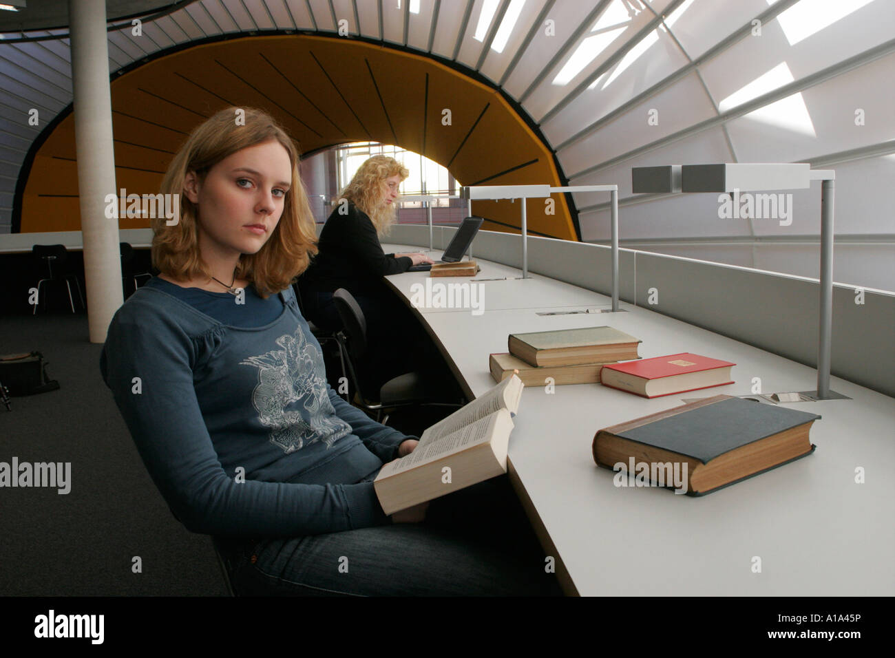 Female student in a library Stock Photo - Alamy