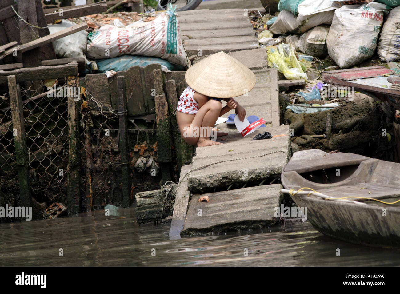 Little Girl using the River Dock as a Toilet, Mekong Delta, Vietnam ...