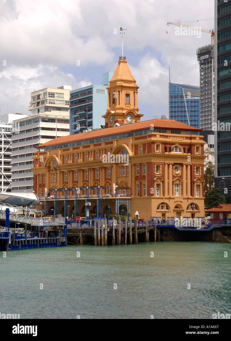 The sandstone and brick Auckland Ferry building and HSBC office tower ...