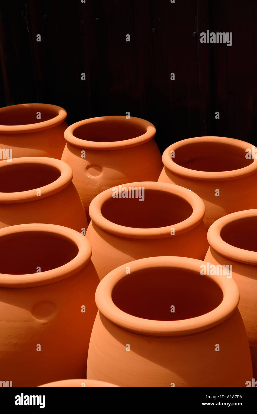 Large terracotta earthenware pots stacked in the sun Morris James ...