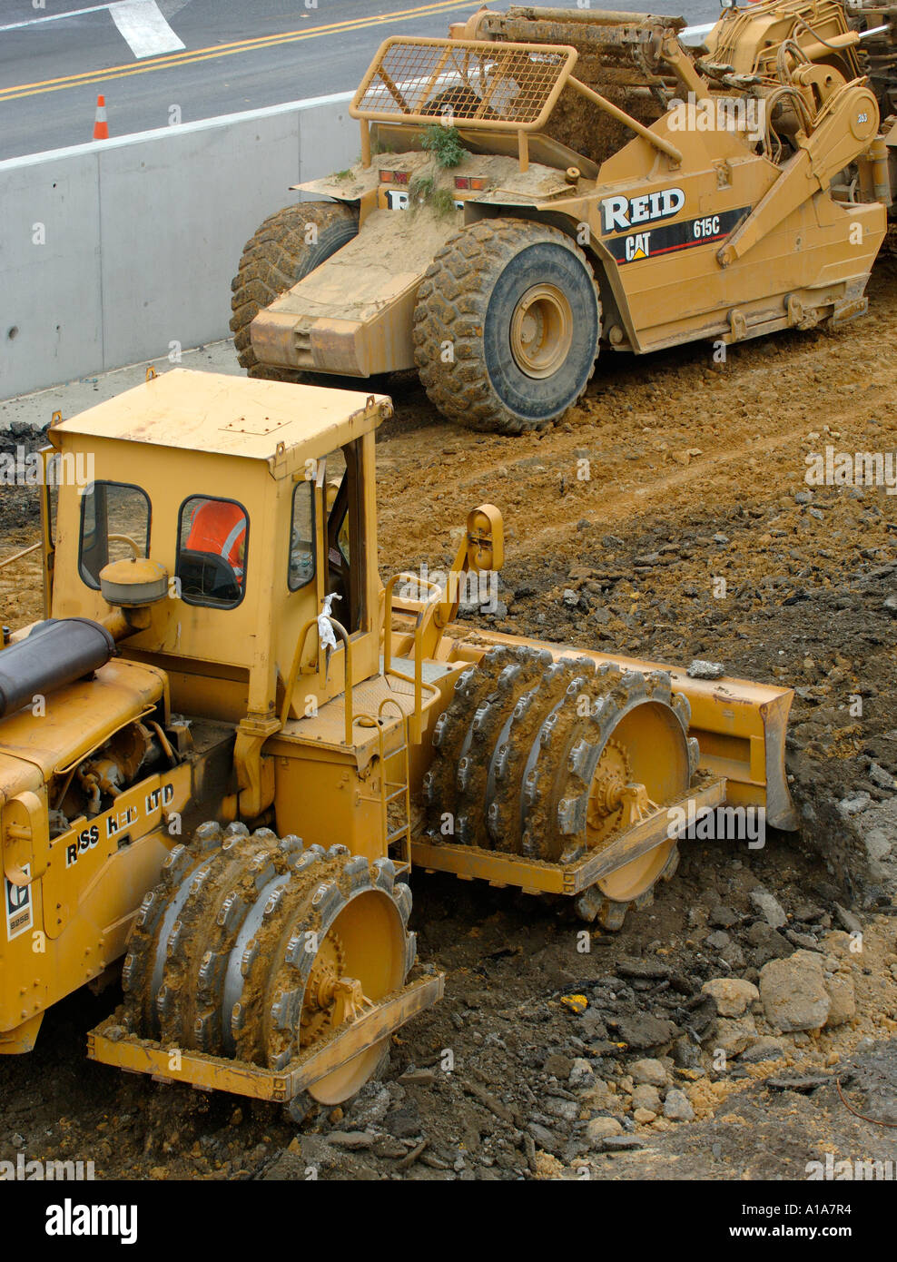 Bulldozer levelling and grading on road construction site Stock Photo ...