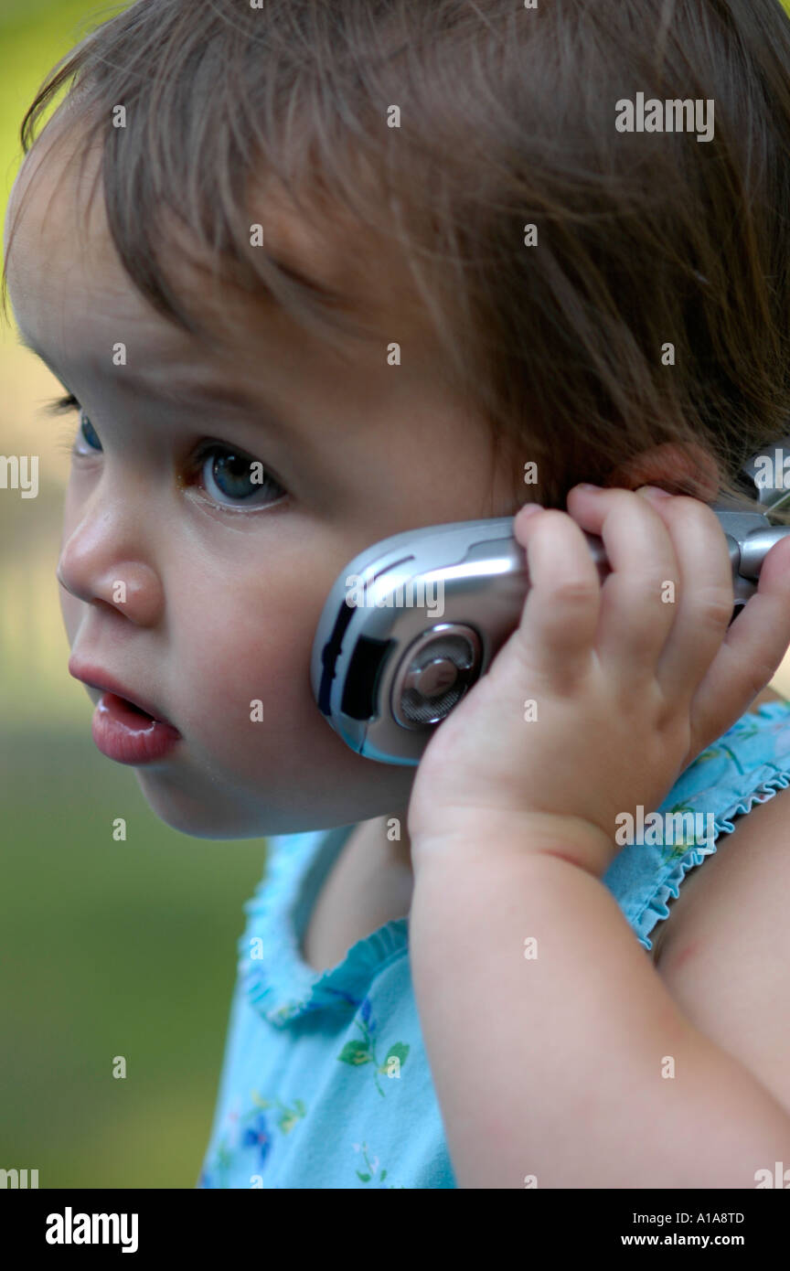 Toddler using a cell phone Stock Photo - Alamy