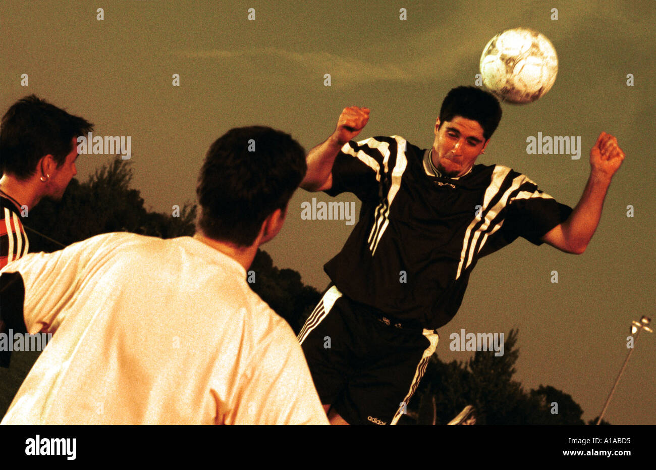 soccer young men playing football Stock Photo - Alamy