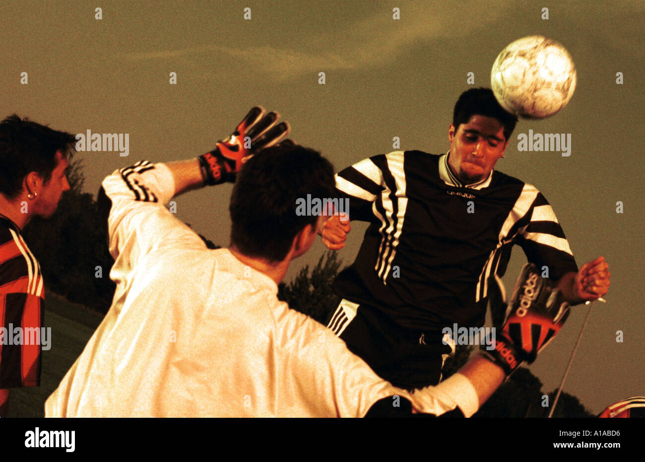 soccer young men playing football Stock Photo - Alamy