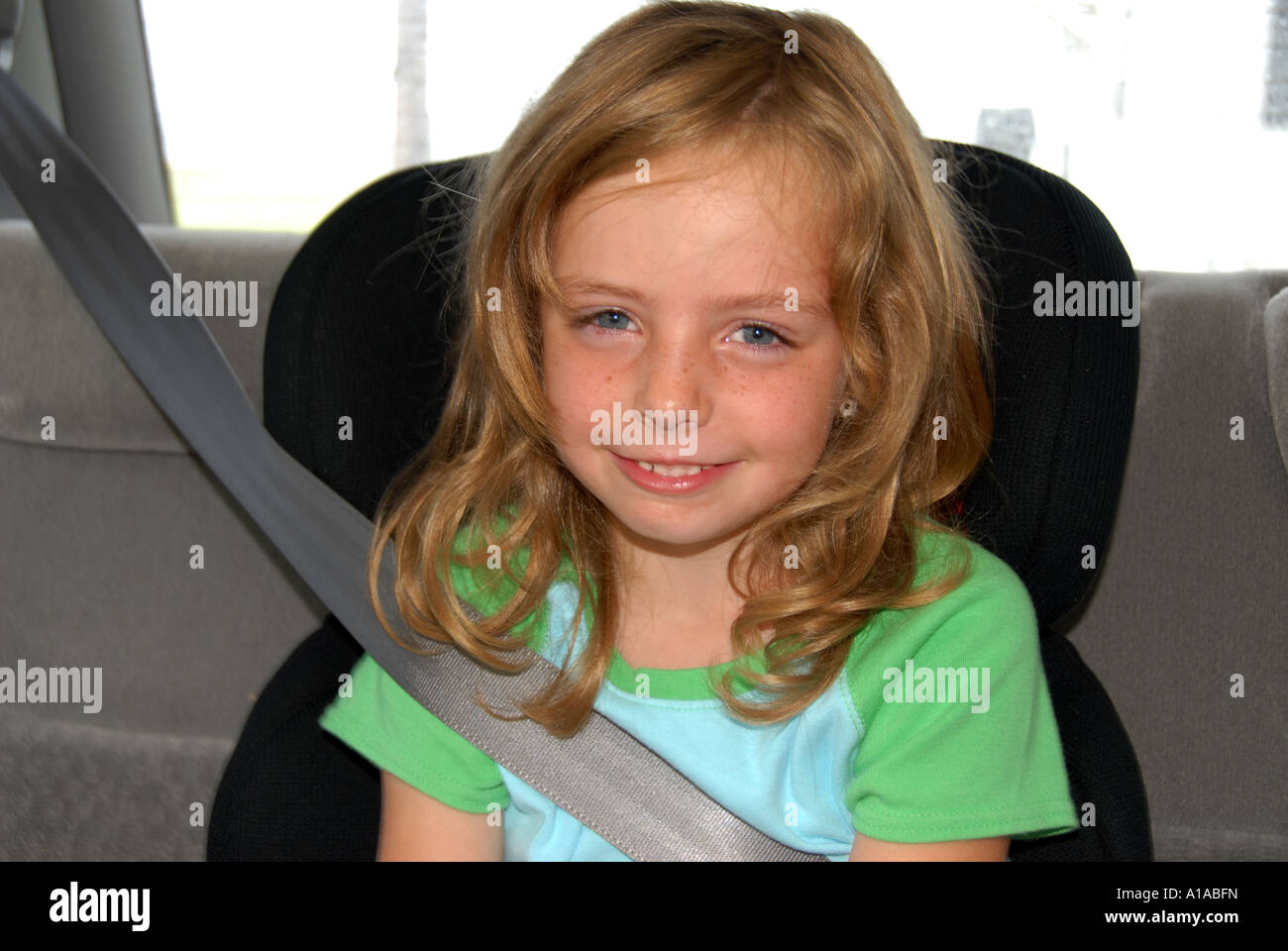 Girl young 6 years freckles smiles strapped in car seat Stock Photo - Alamy