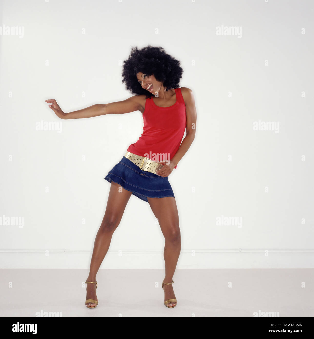 Woman with afro dancing Stock Photo - Alamy