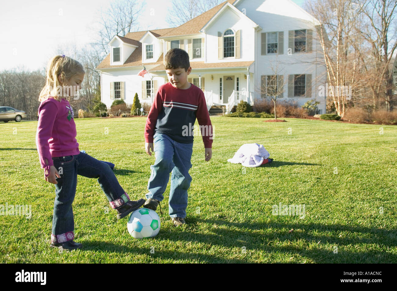 Brother and sister playing football Stock Photo - Alamy