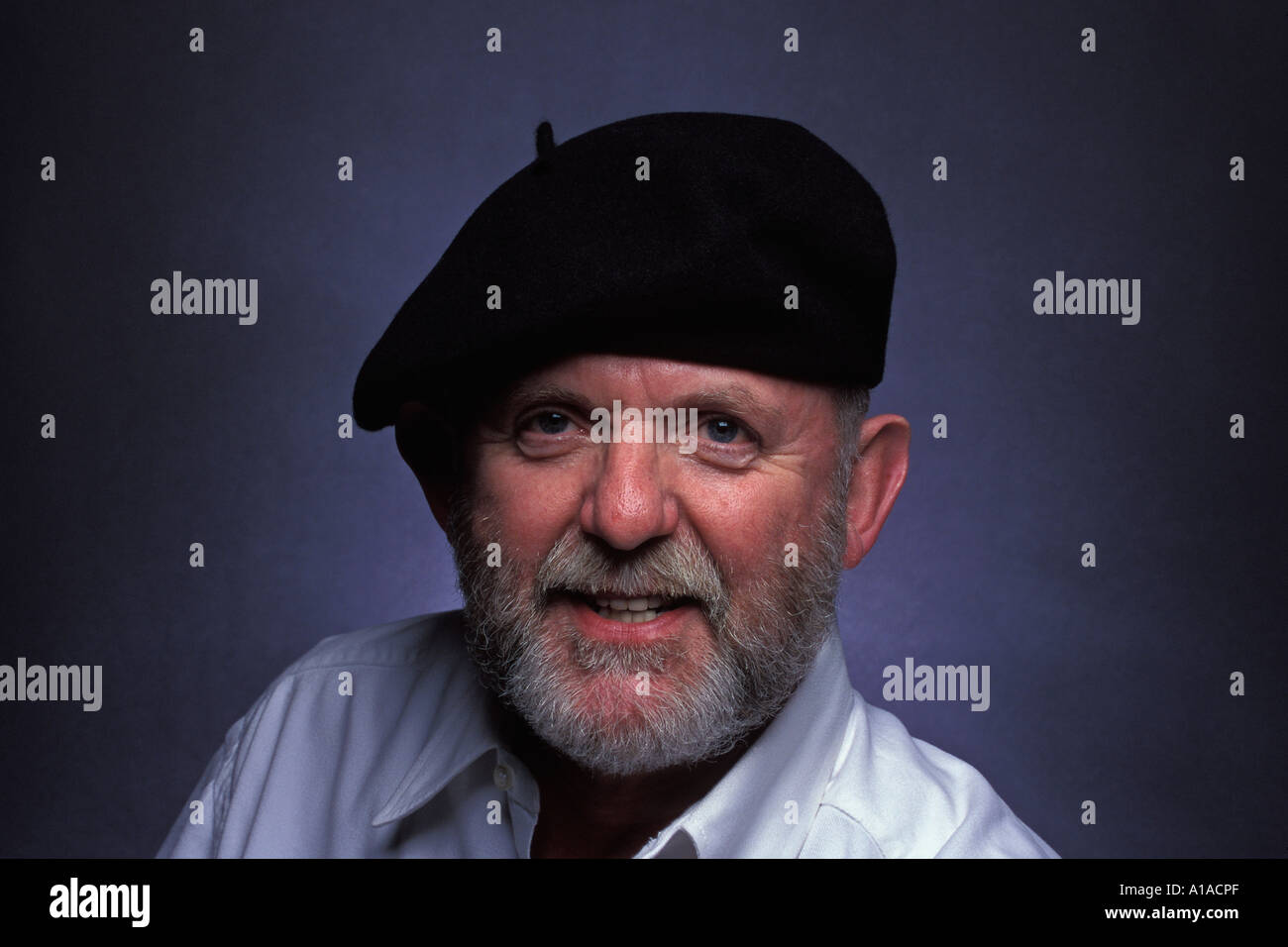 Man with grey beard wearing French beret and white shirt Stock Photo ...