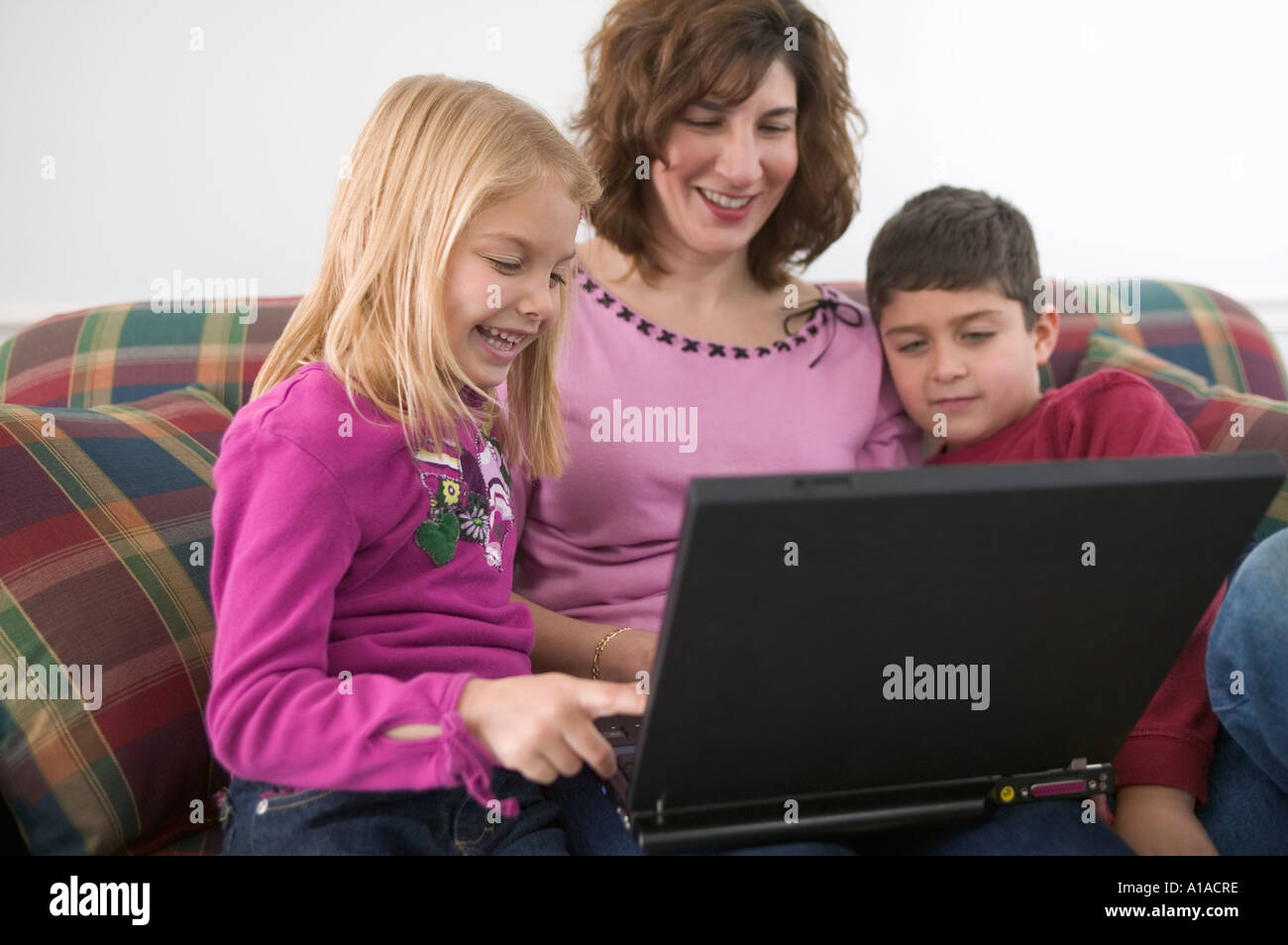 Mother and children using computer Stock Photo - Alamy