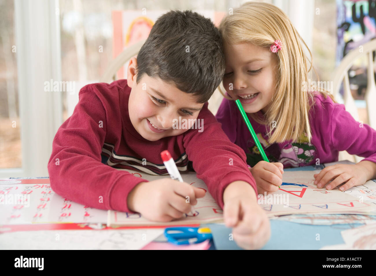 Brother and sister doing homework Stock Photo - Alamy