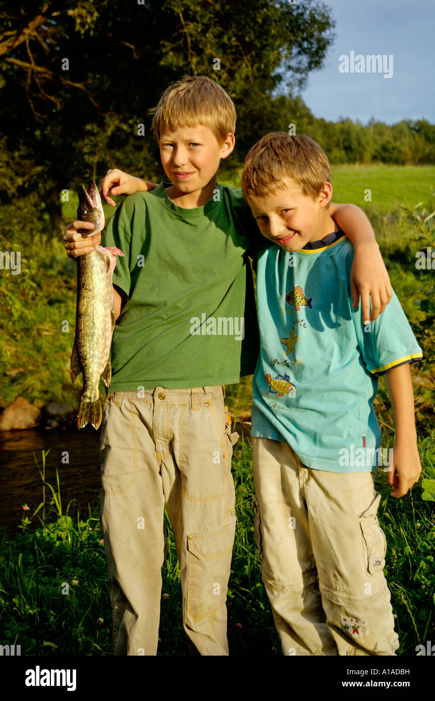 Boys laughing holding fish hi-res stock photography and images - Alamy
