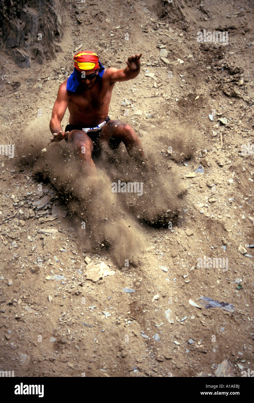USA Alaska Seward Runner leaps while scrambling down 3020 Mount ...