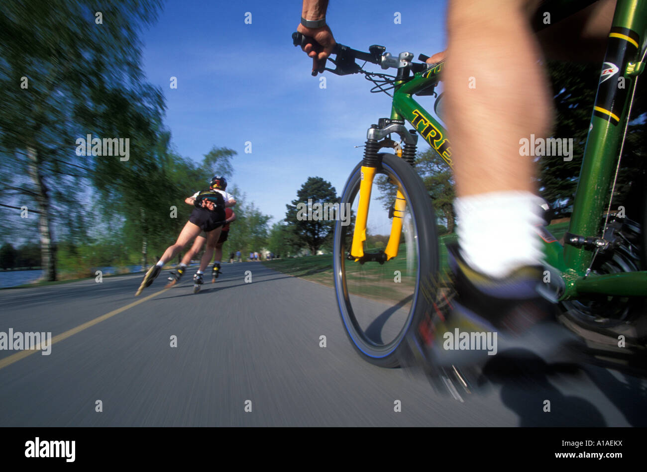 USA, Washington, Seattle, Mountain biker rides along busy trail ...
