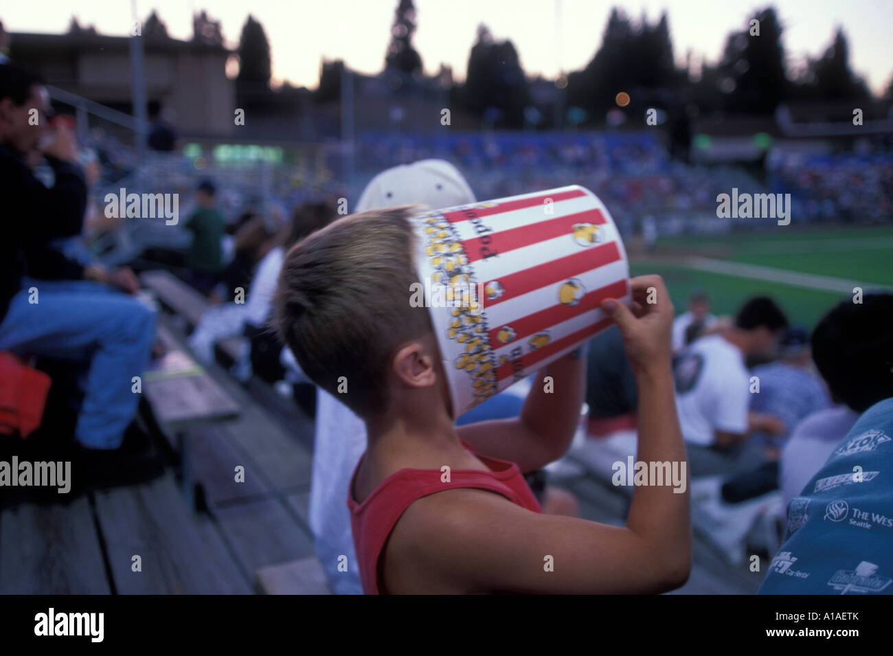 USA Washington Young baseball fan finishes off popcorn at Everett ...