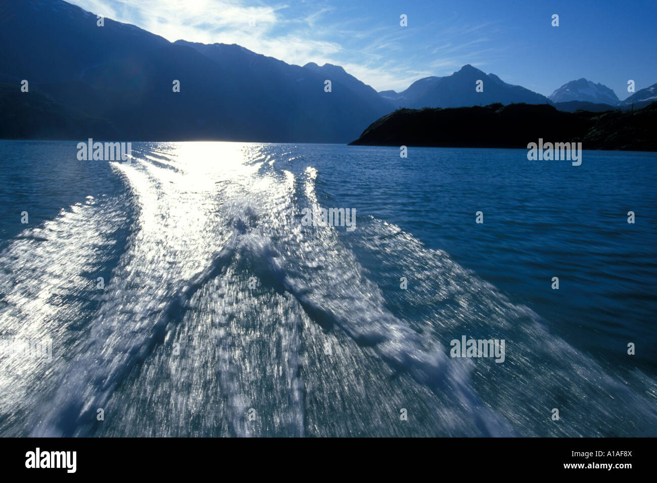 USA Alaska Glacier Bay National Park Summer sun reflects off small boat ...