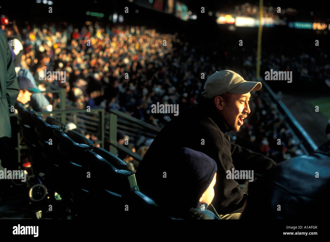 USA Washington Setting sun lights baseball fans watching Seattle ...
