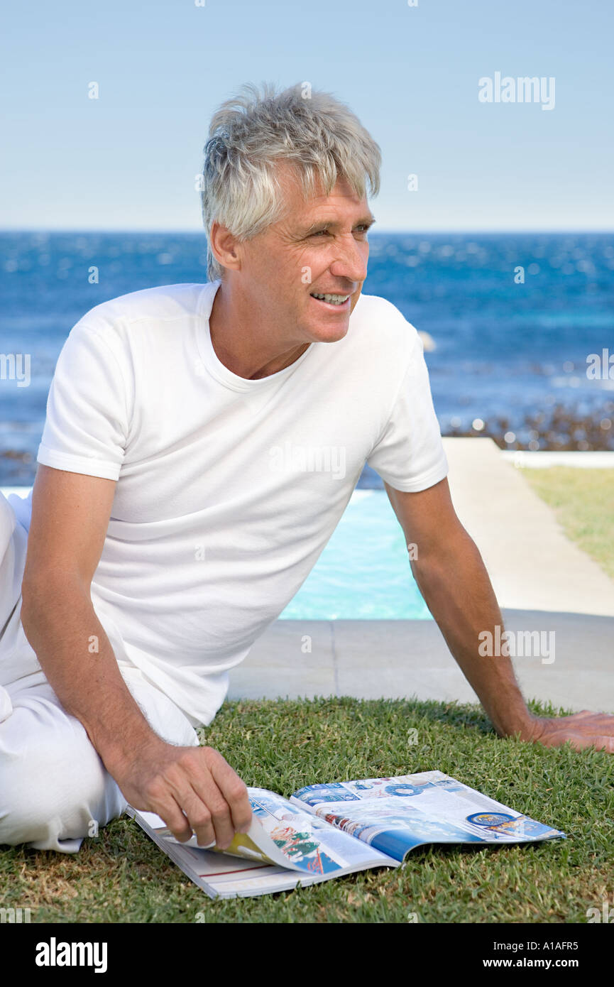 Man outside with magazine Stock Photo - Alamy