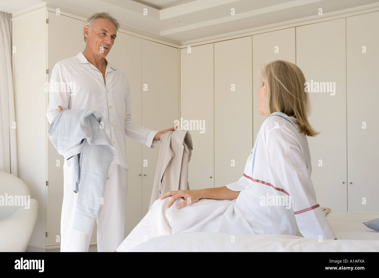 Mature couple in bedroom Stock Photo - Alamy