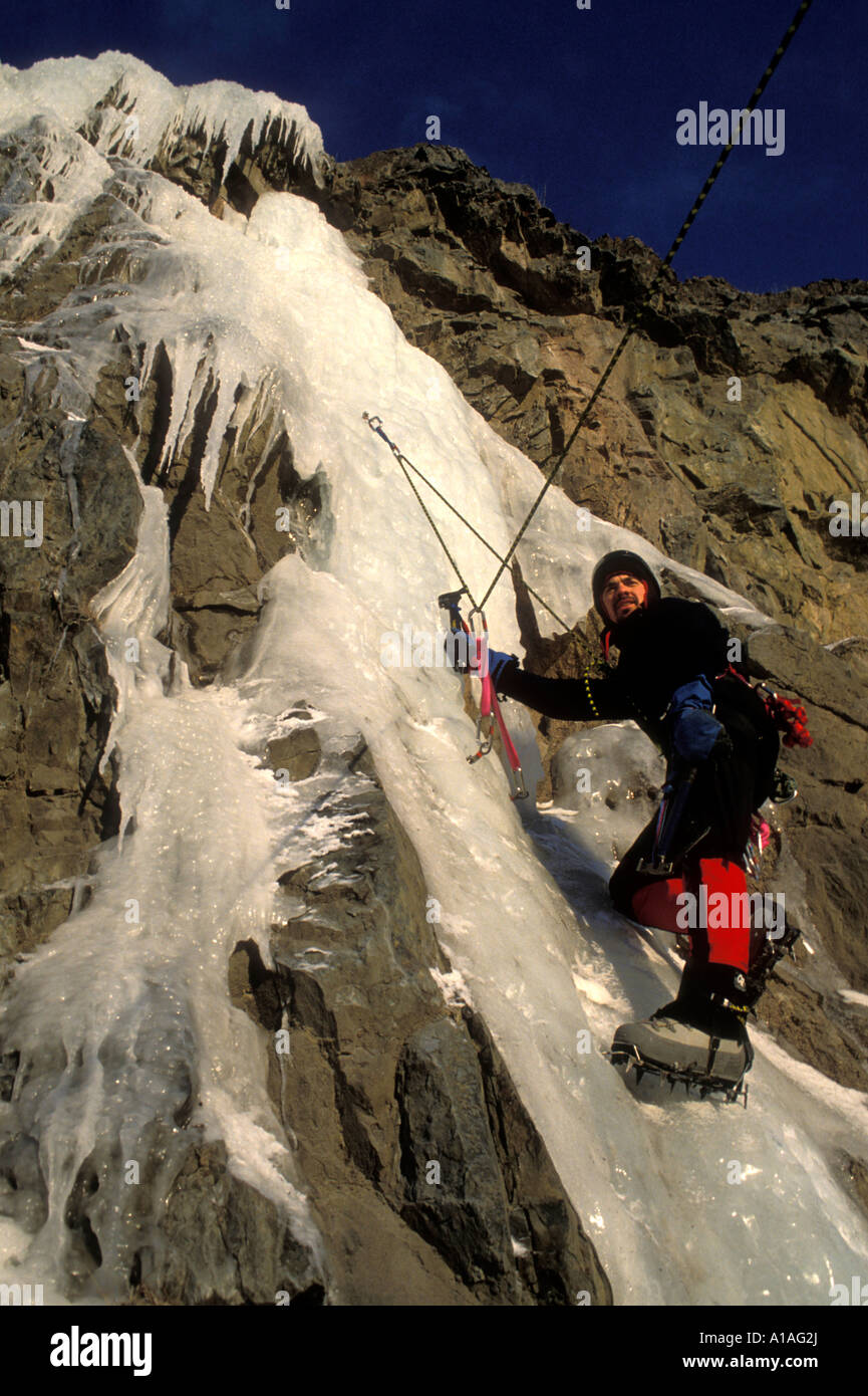 USA Alaska Chugach State Park MR Rick Ford climbs ice waterfall along ...