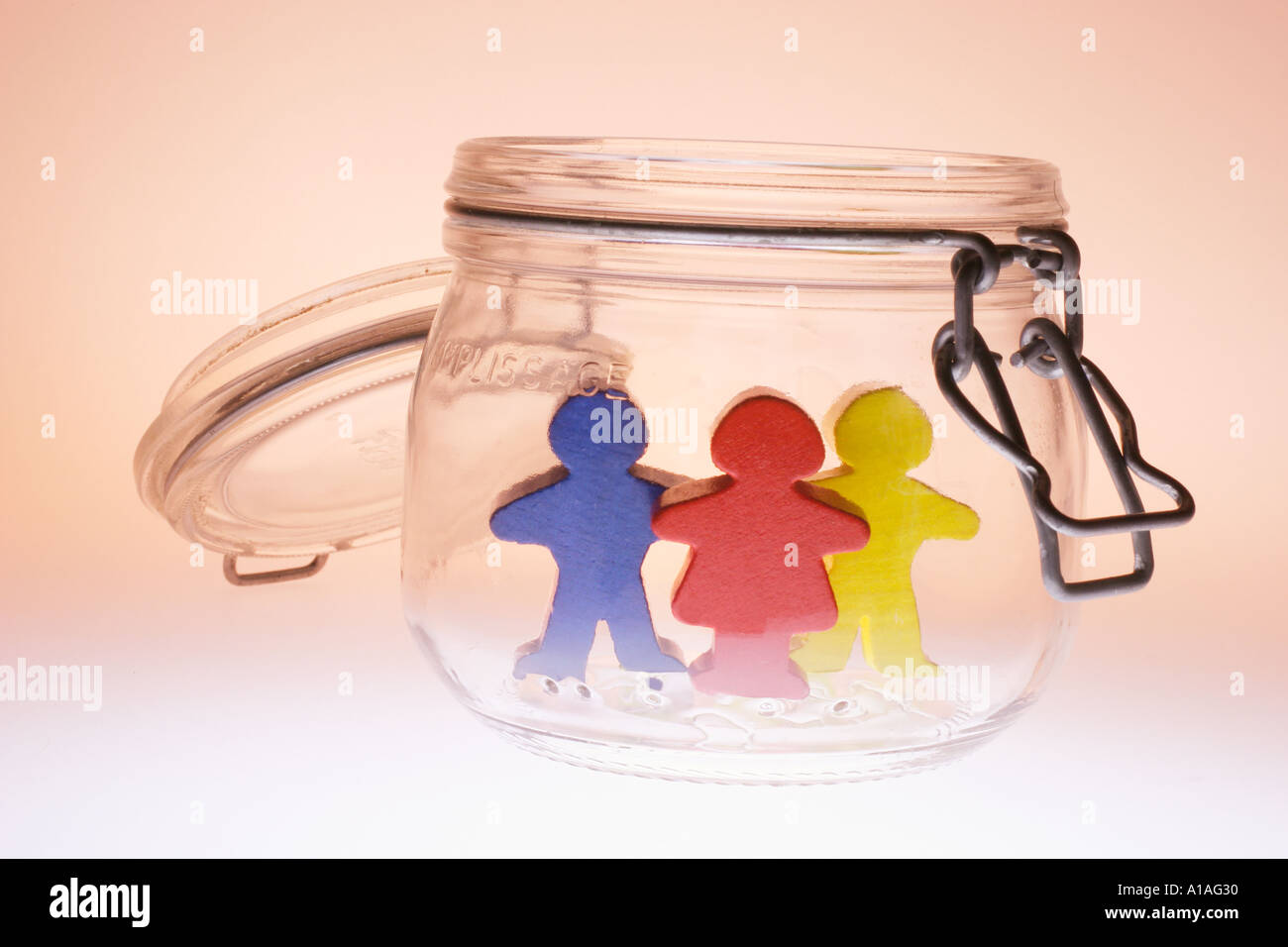 Wooden Children Figures in Glass Jar Stock Photo - Alamy