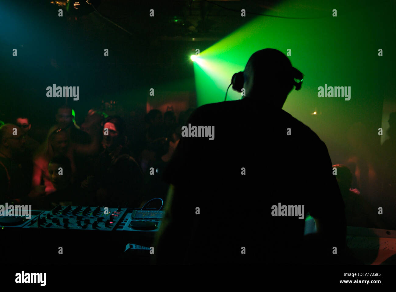 Club DJ Behind the Decks of a Crowded Nightclub Stock Photo - Alamy