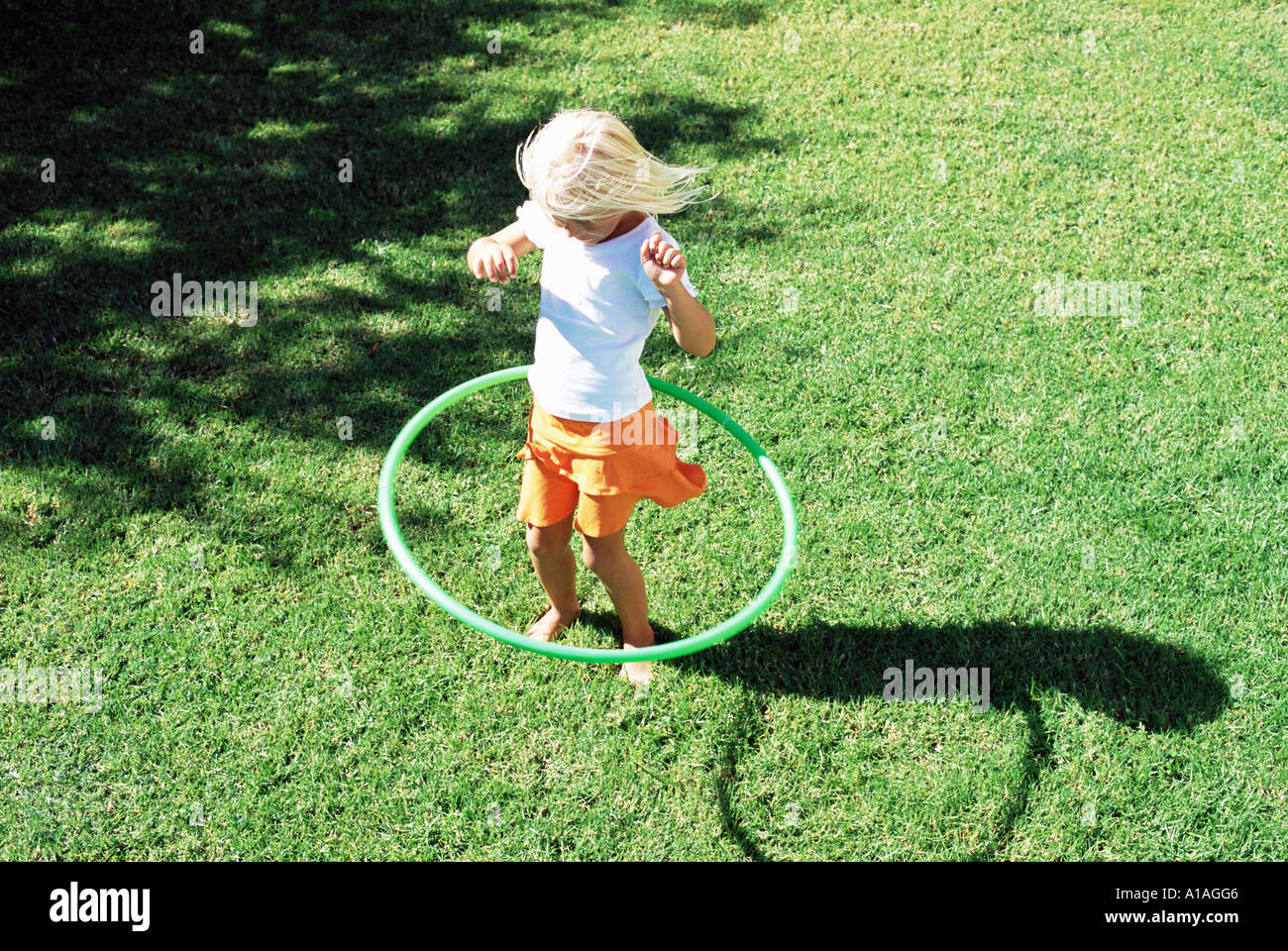 Girl playing with hula hoop Stock Photo - Alamy