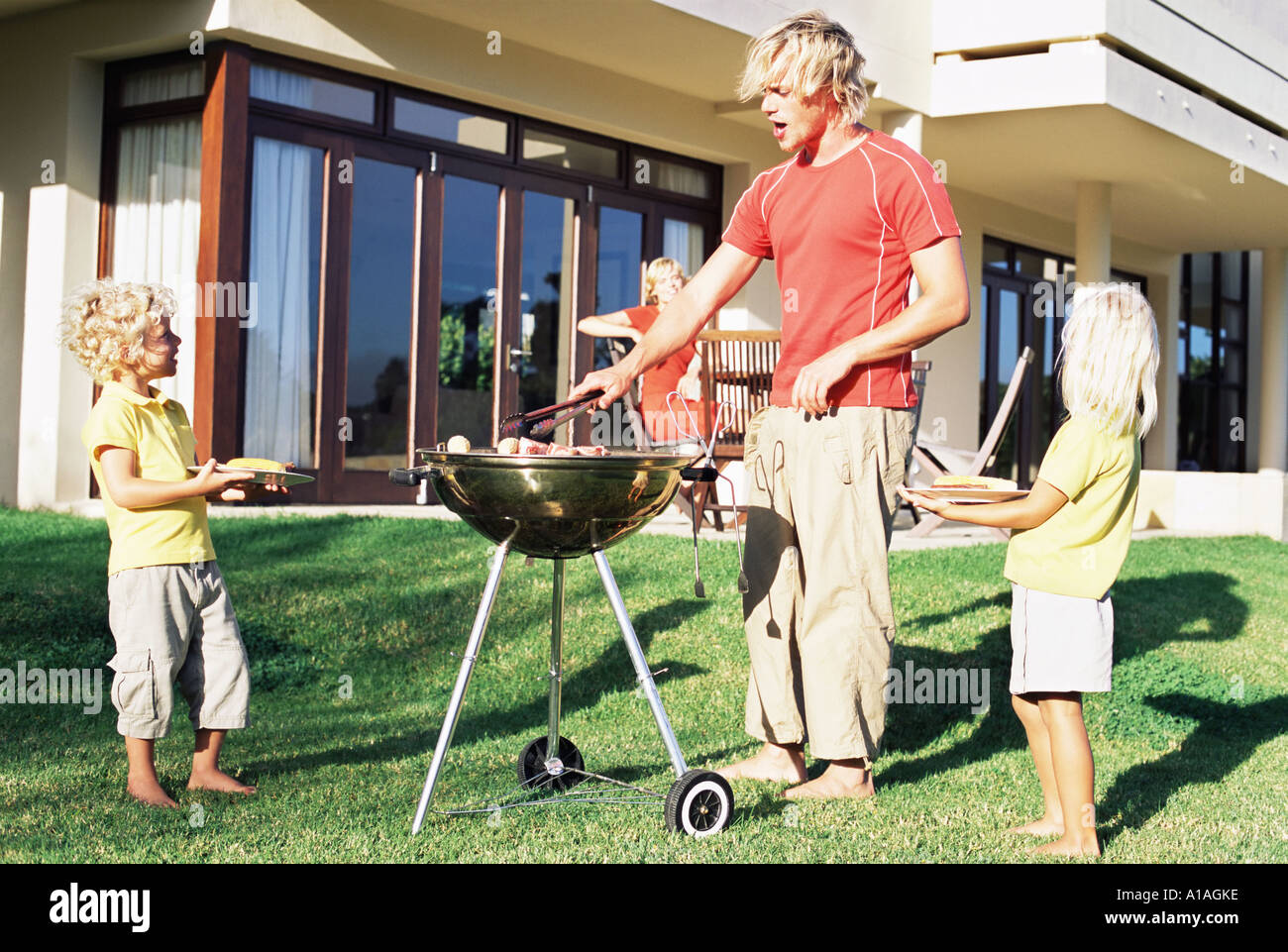 Father doing a barbecue for his family Stock Photo - Alamy