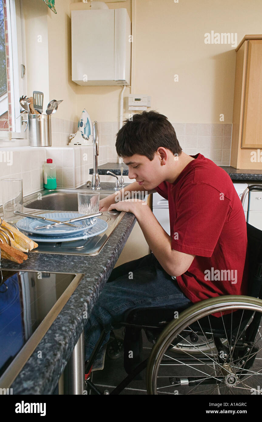 Disabled man washing up Stock Photo - Alamy