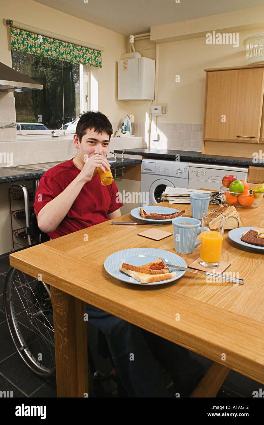 Disabled man having breakfast Stock Photo - Alamy