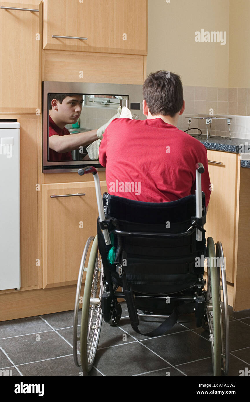 Disabled man opening oven Stock Photo - Alamy