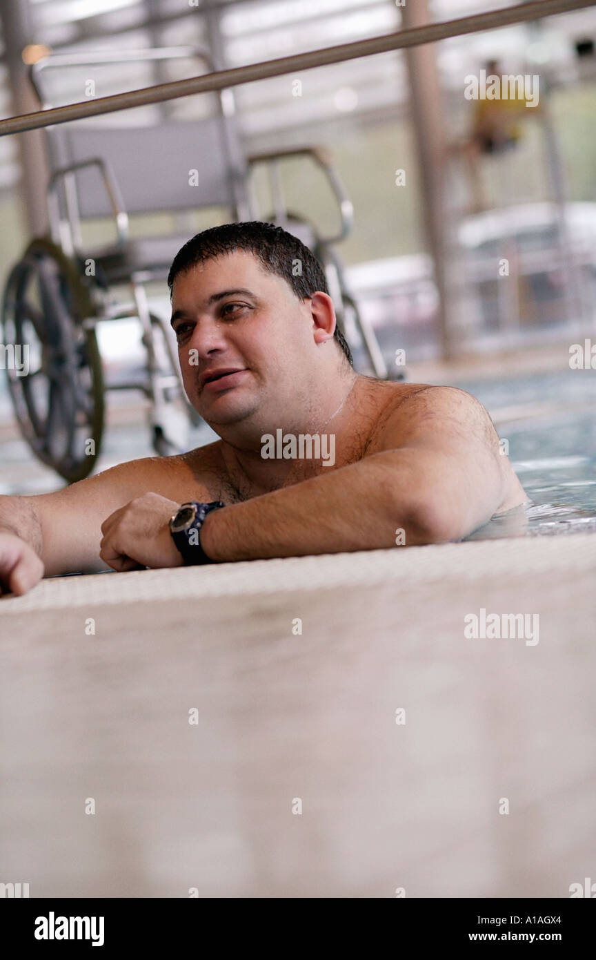 Man resting on the edge of a swimming pool Stock Photo - Alamy