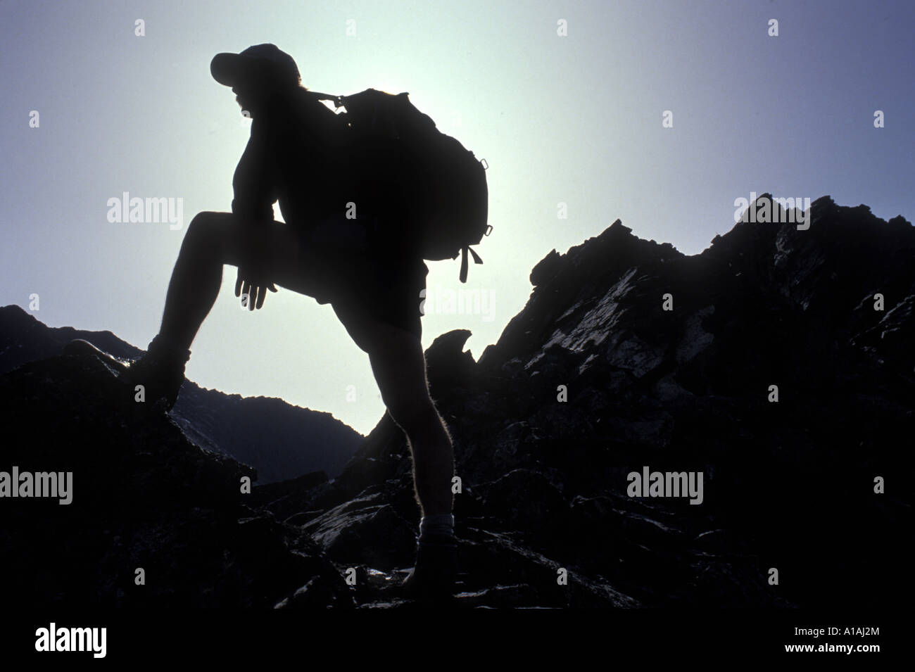 USA Alaska Arctic National Wildlife Refuge Silhouette of backpacker ...