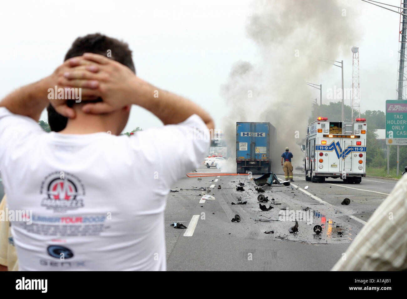 Bystander observes the aftermath of a car accident on an American ...