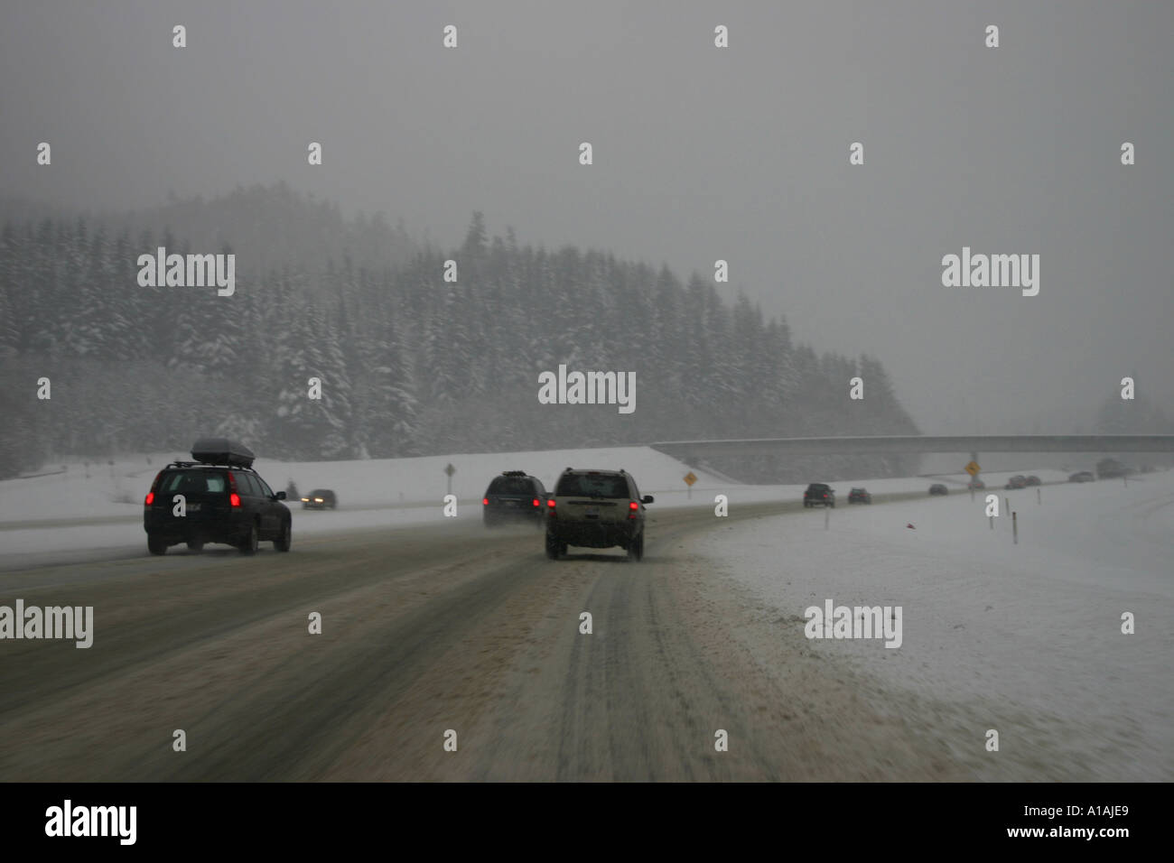 Traffic on Interstate highway 90 in a winter snowstorm Snoqualmie Pass ...