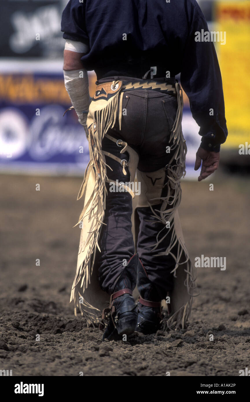 USA California Cowboy walks through mud while competing in Saddle Bronc ...