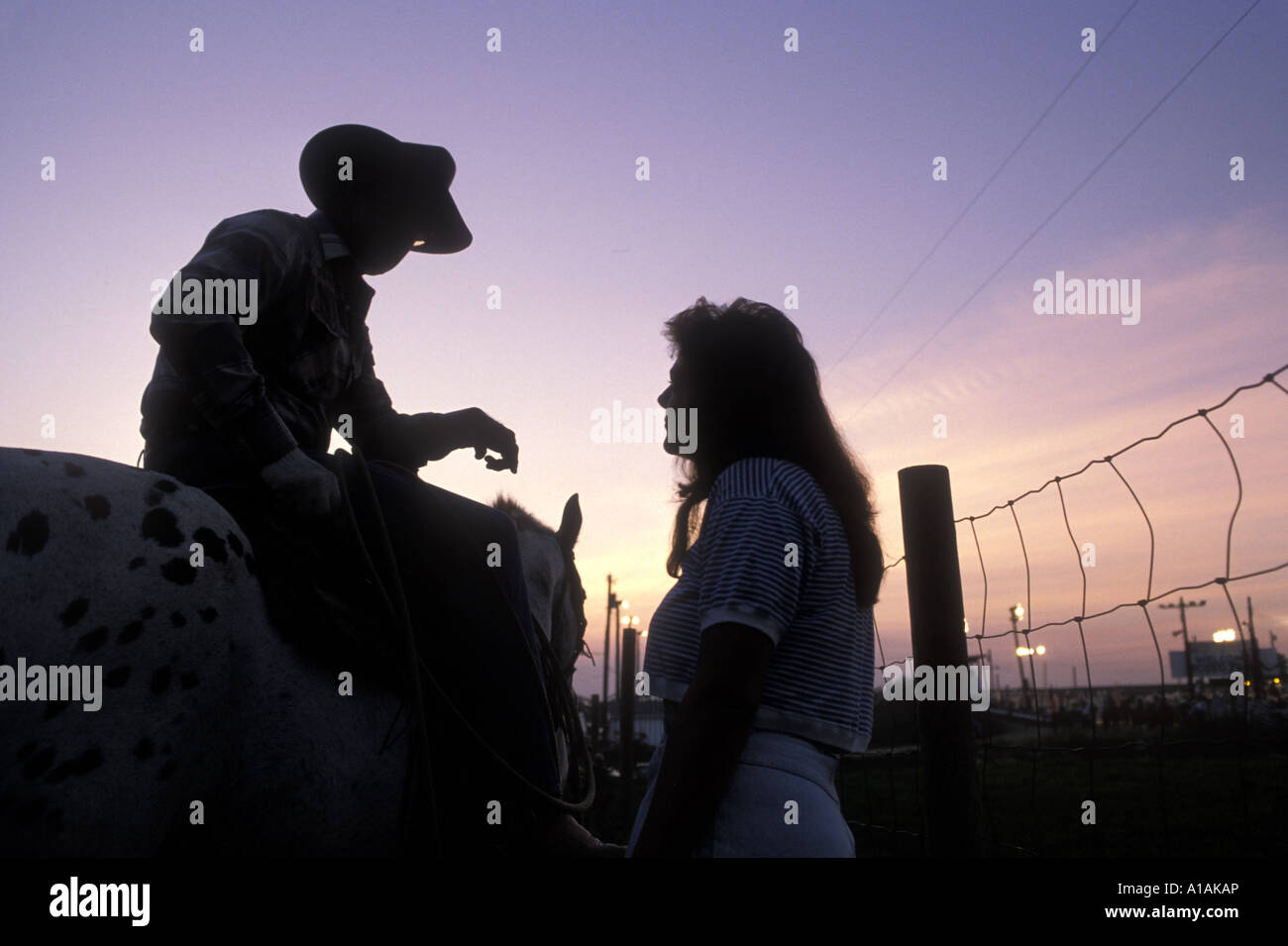 USA New Jersey Woodstown Silhouette of rodeo cowboy chatting with ...