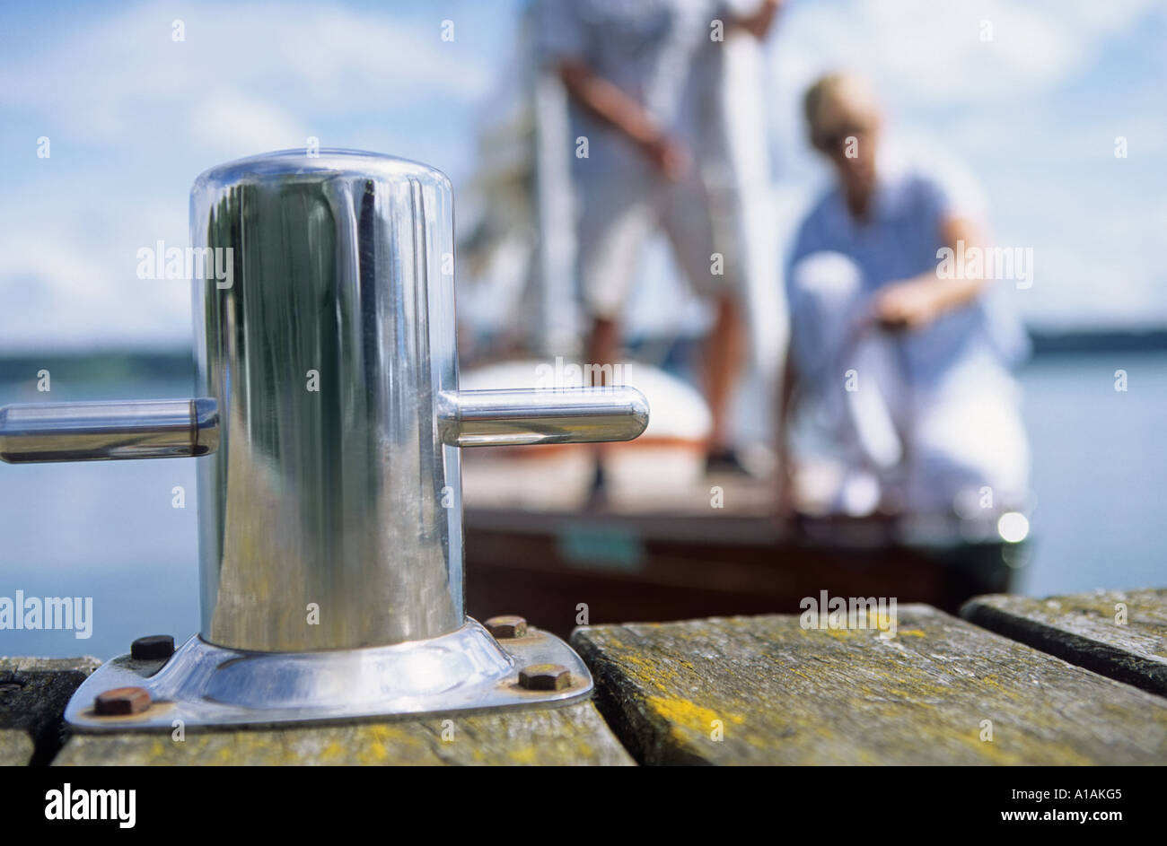 People on boat approaching jetty Stock Photo - Alamy
