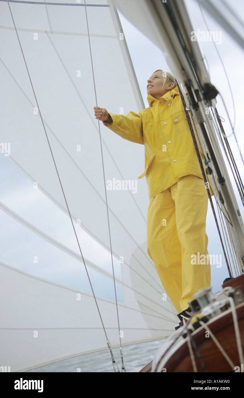 Woman adjusting sail on boat Stock Photo - Alamy