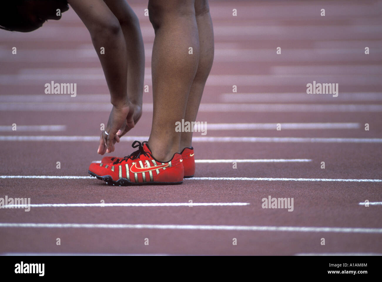 USA, Washington, Seattle, Sprinter stretches before 100 meter women's ...
